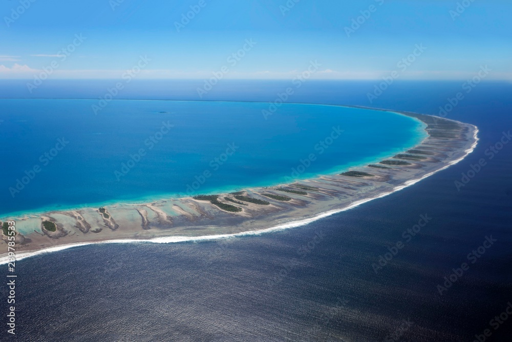 Coral reef with clouds, reef fringes in the sea, Tikehau Atoll, Pacific ...