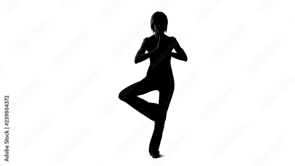 Young female shadow practicing yoga, tree pose exercise, soul and body ...