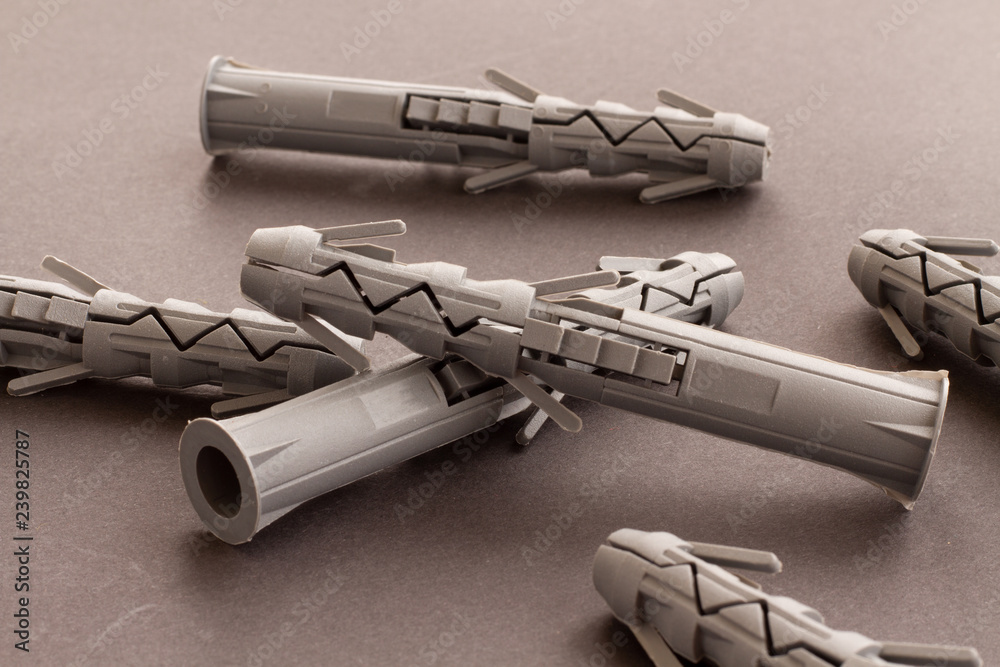 Clear pfoto of Gray plastic wall plugs and building anchors are lying ...
