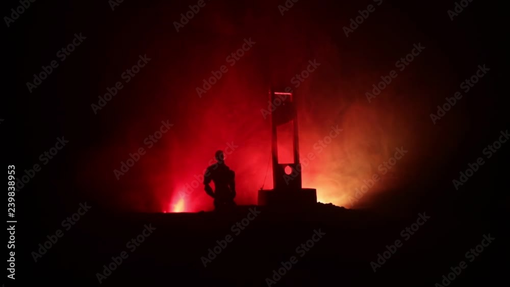 Horror view of Guillotine. Human at guillotine on a dark foggy ...