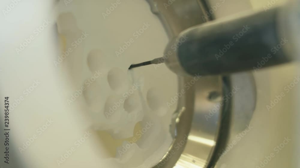 Dental milling cnc machine carving out shape of human teeth close-up ...