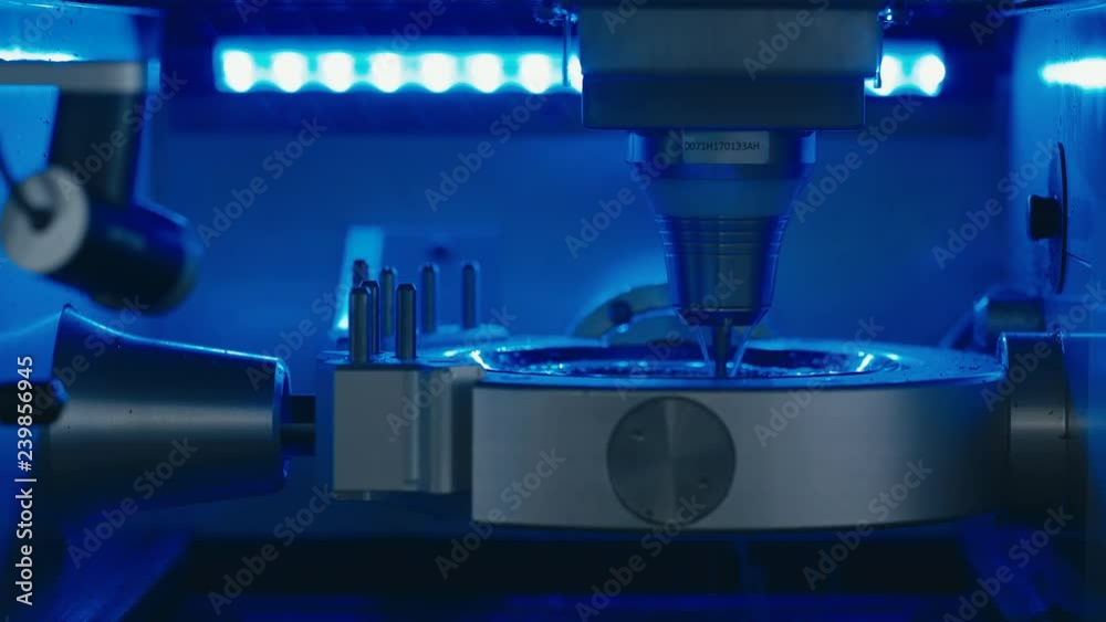 Dental milling machine carving out shape of human teeth from metal ...