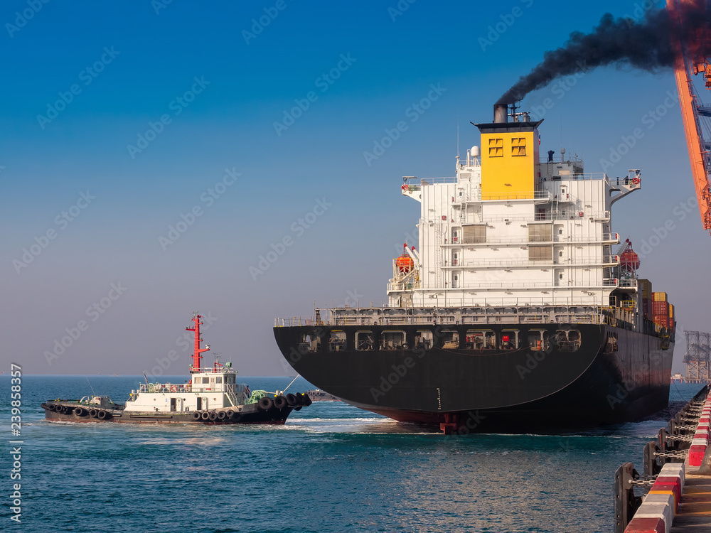 The container vessel to be berthing and assist by the tugs boat for ...