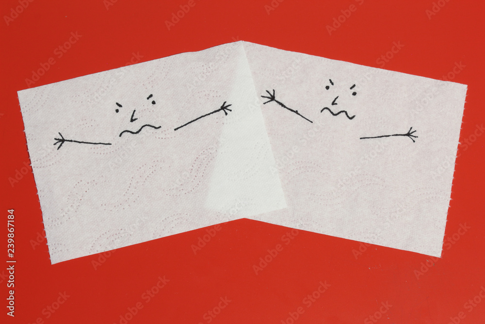 Two white toilet paper pieces sketched with furious characters close to ...