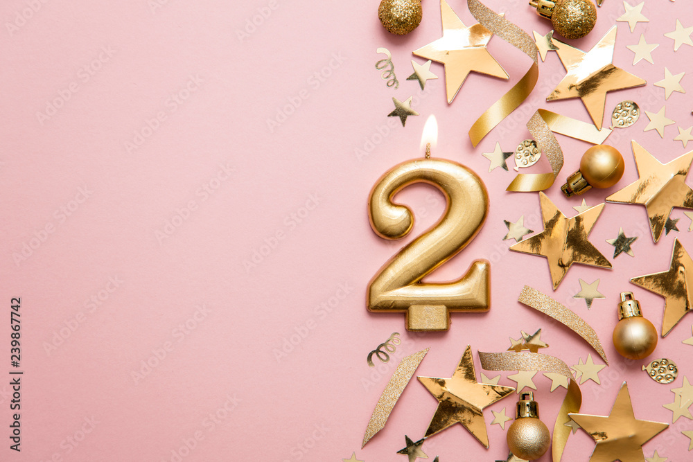 Number 2 gold celebration candle on star and glitter background Stock ...