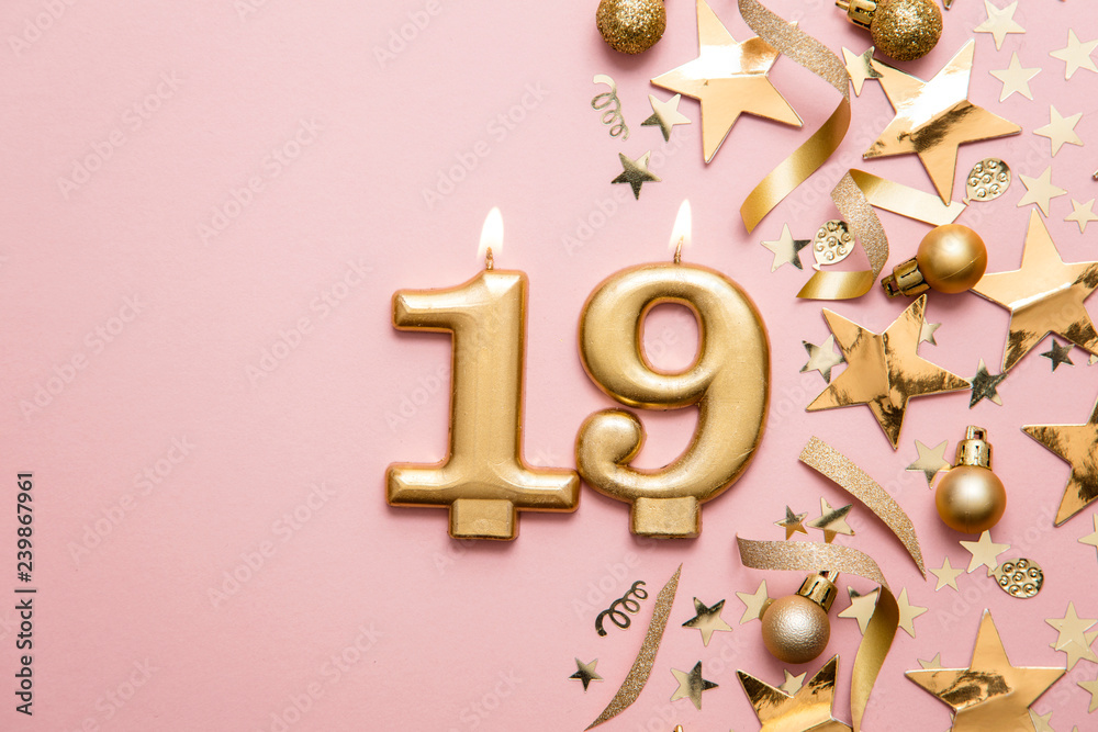 Number 19 gold celebration candle on star and glitter background Stock ...