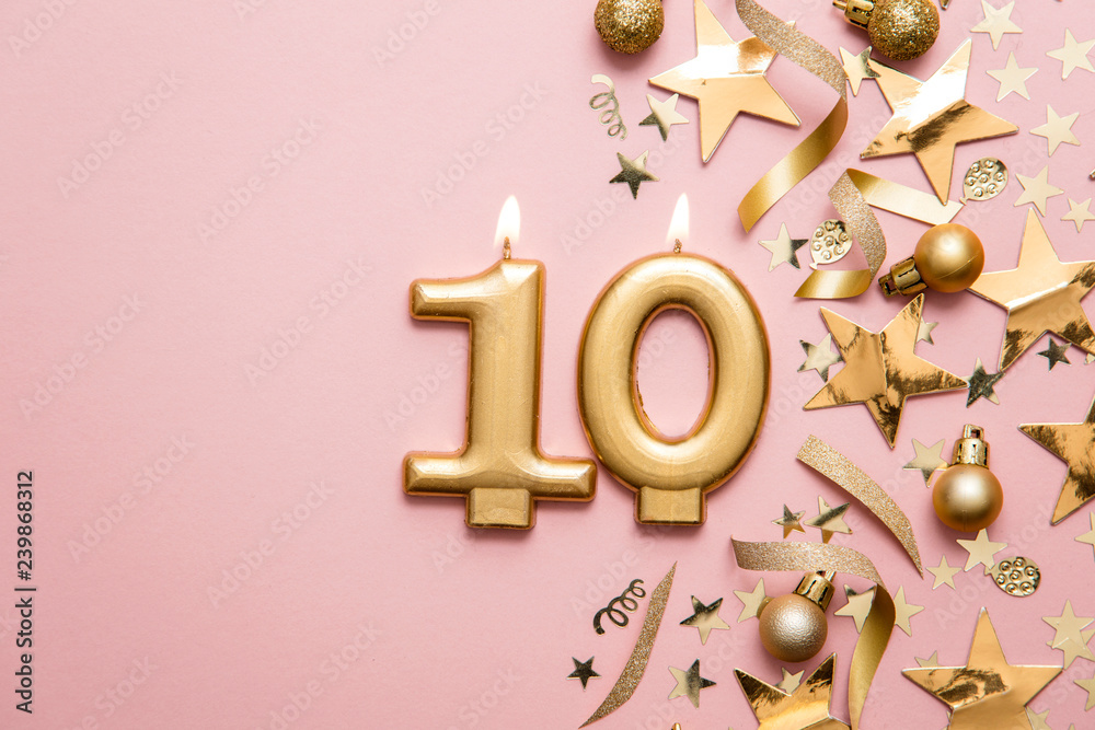 Number 10 gold celebration candle on star and glitter background Stock ...
