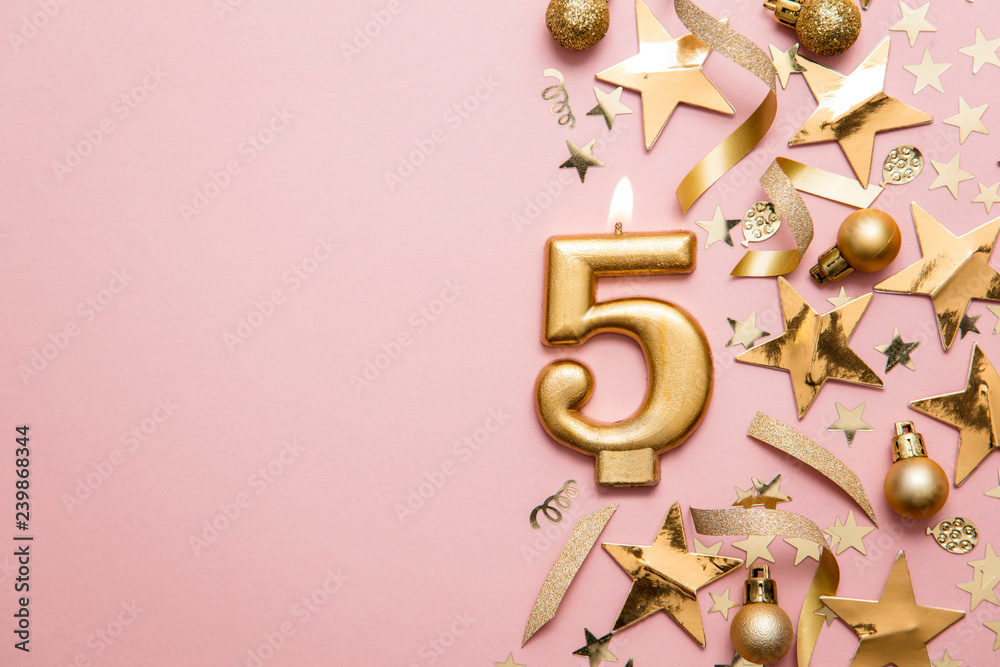 Number 5 gold celebration candle on star and glitter background ...