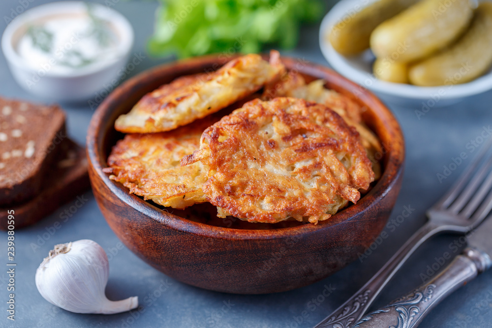 Draniki - potato fritters. potato pancakes lie on a plate. The national ...