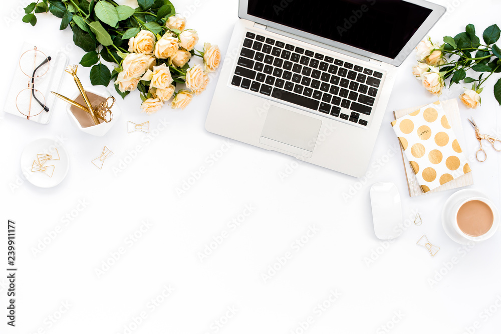 Female workspace with laptop, roses flowers bouquet, golden accessories ...