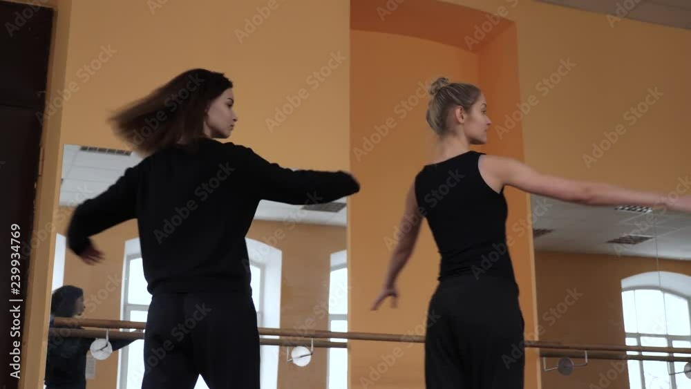 A beautiful ballet dancer teaching a model how to perform pique turns ...