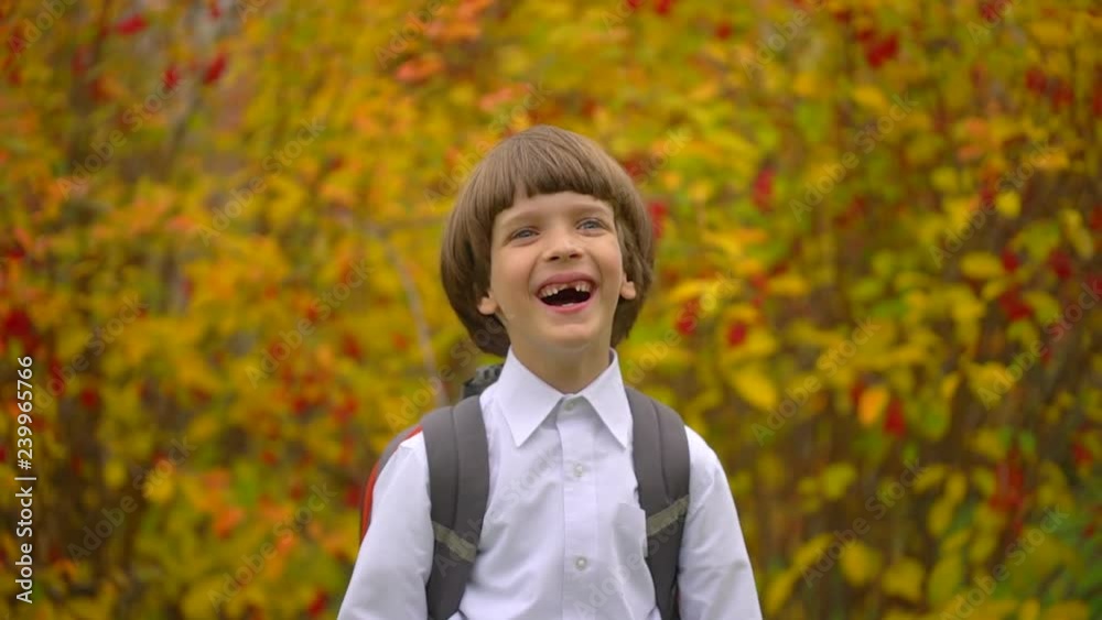 Portrait of smiling happy cute boy schoolboy with backpack laughing to ...
