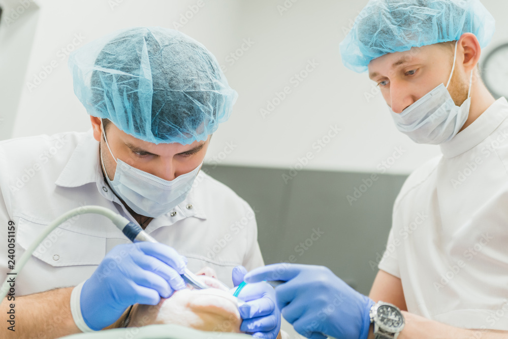 Doctor used microscope. Dentist is treating patient in modern dental ...