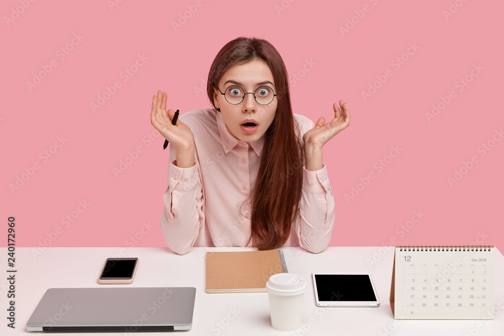 Young female perfectionist arranges all things neatly, has stupefied ...