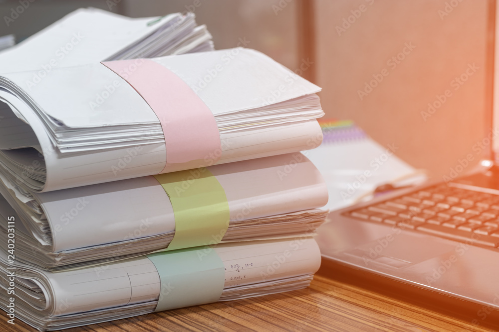 Pile of unfinished homework on teacher's desk waiting to be managed ...