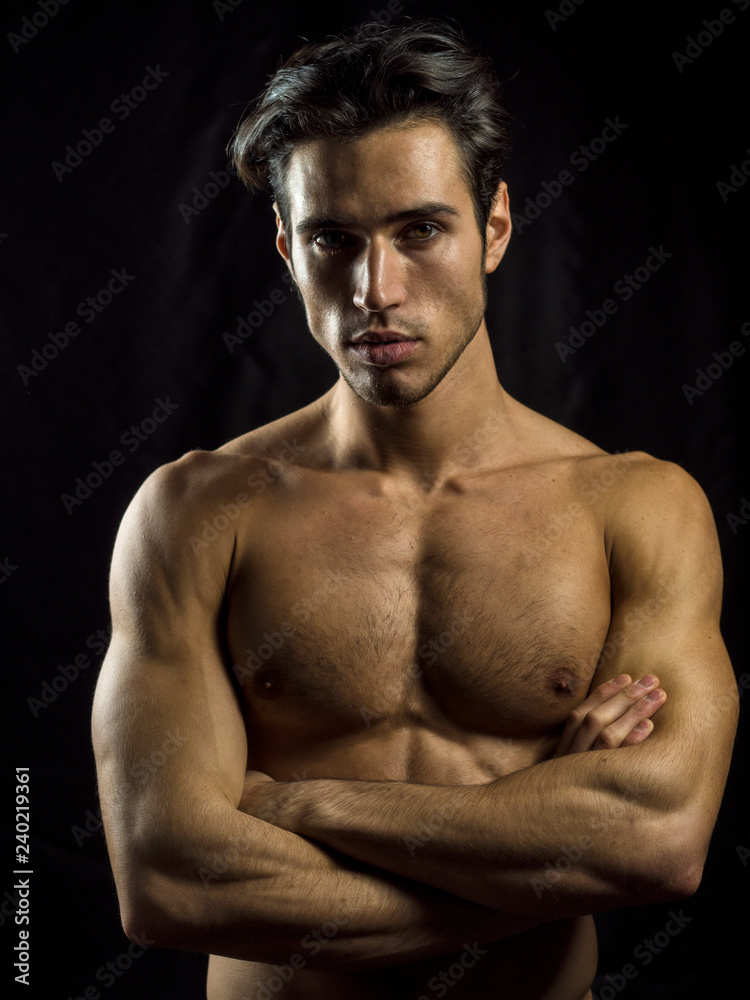 Handsome muscular shirtless young man standing confident, front view ...