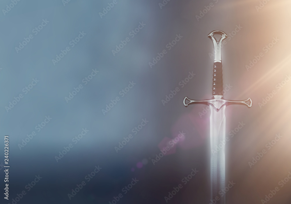 mysterious and magical photo of silver sword over black background with ...