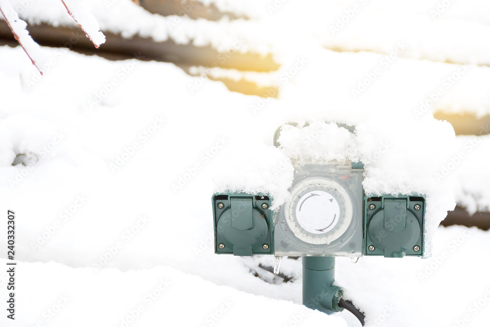 Non focus a green time switch cover with snow in garden with background ...