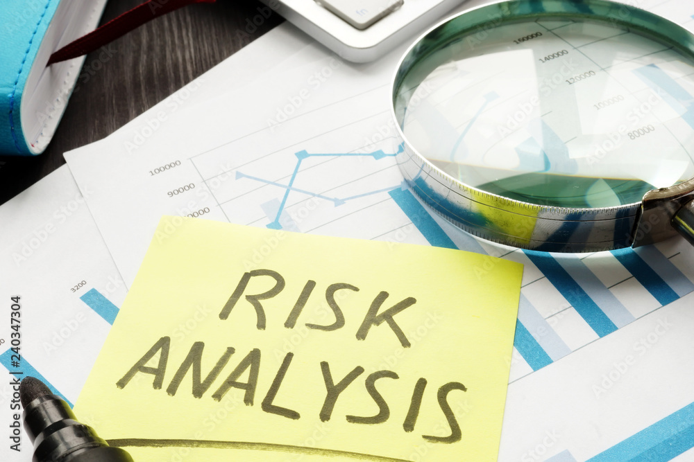 Risk analysis concept. Magnifying glass and business documents. Stock ...
