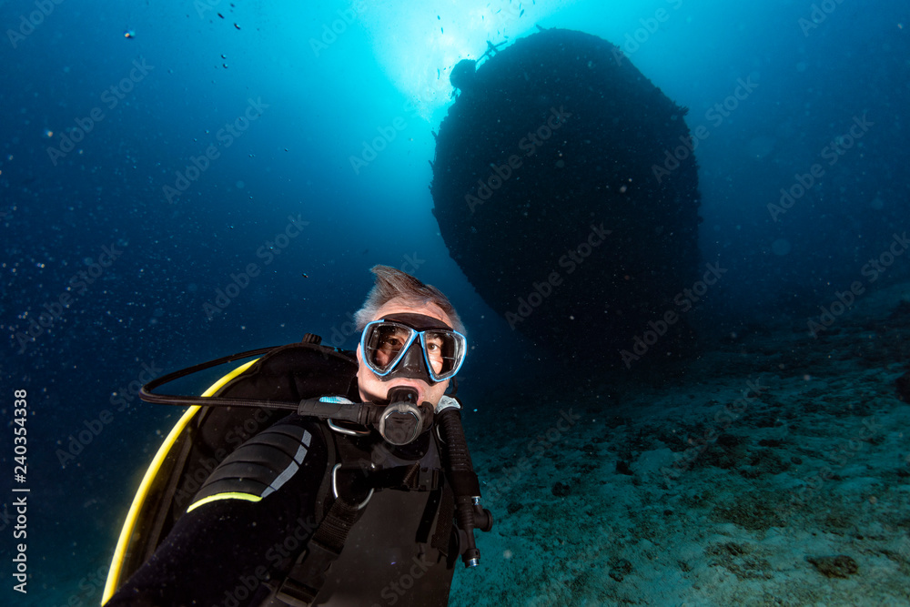 scuba diver diving Ship Wreck in maldives indian ocean Stock Photo ...