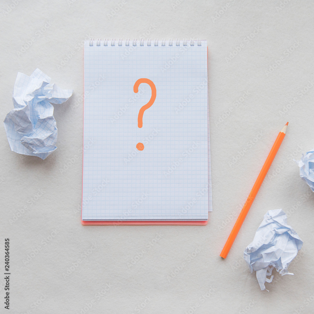 Blank note paper with pencil. Opened notepad. Around the notepads lies lot crumpled paper. Solve ...