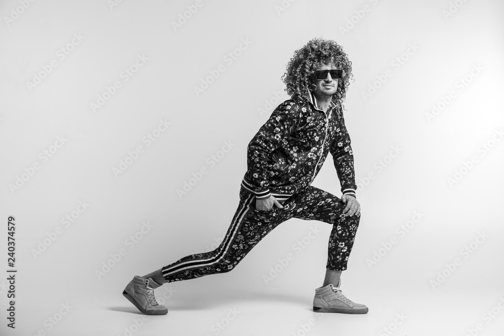 Adult positive smiling funky man with curly hair style in suglasses and ...