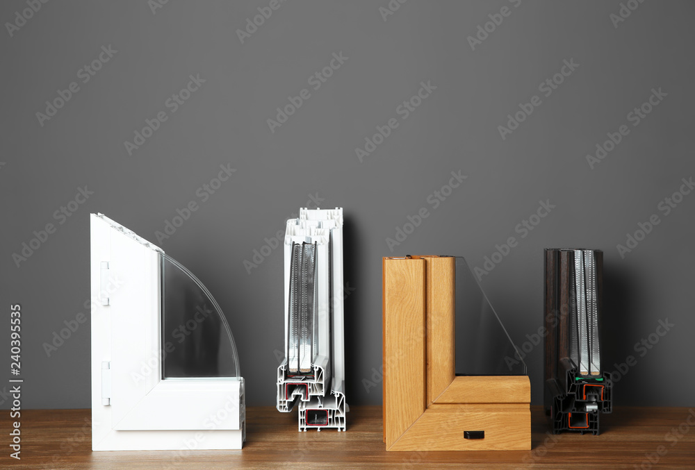 Samples of modern window profiles on table against gray wall ...
