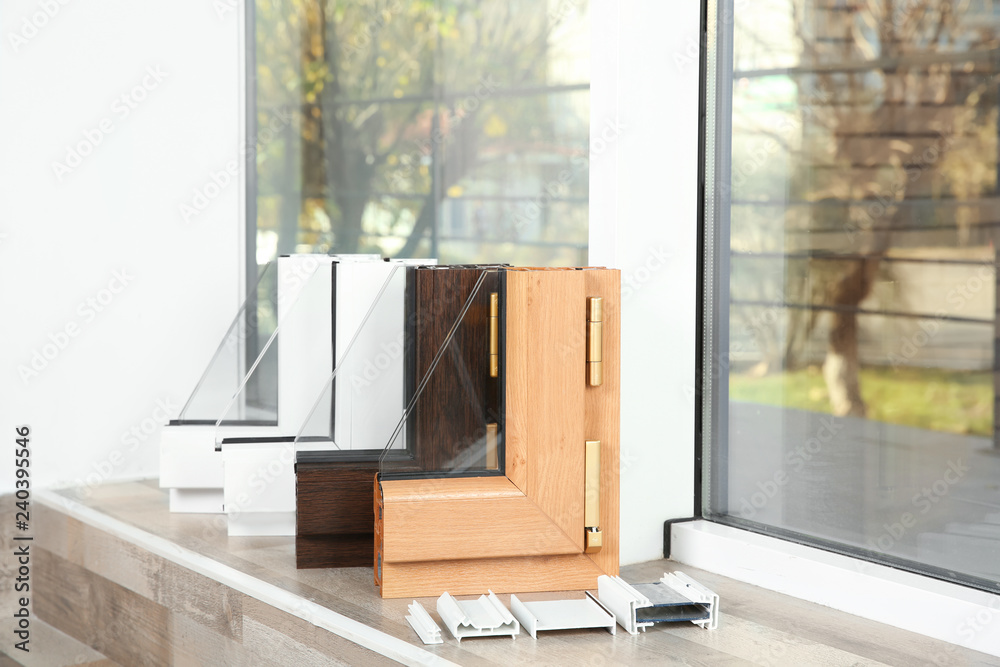 Samples of modern window profiles on sill indoors, space for text ...