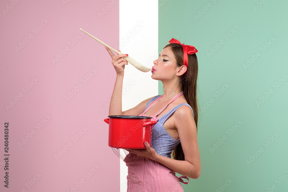 pin up woman with trendy makeup. retro woman cooking in kitchen. pinup ...