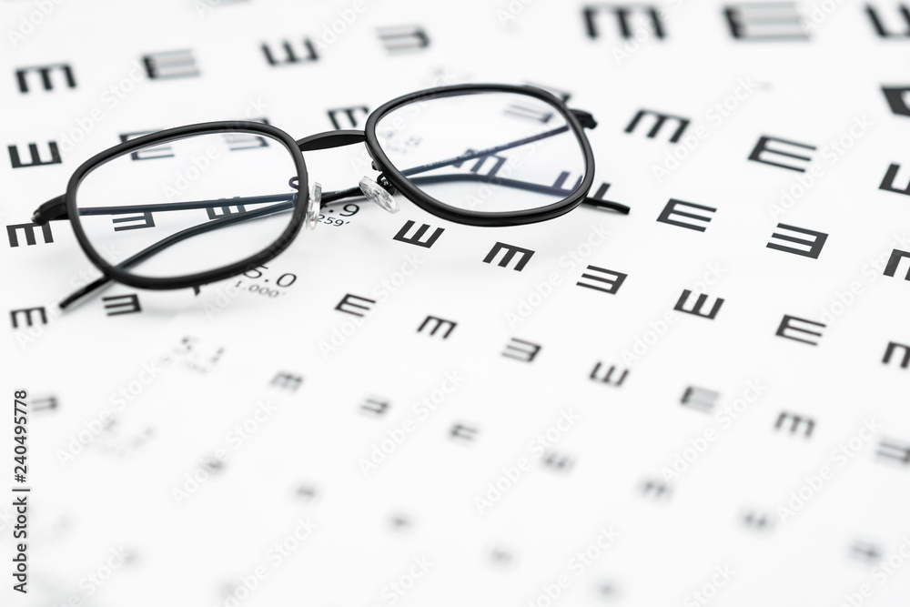 Eyeglasses and visual acuity chart in white background Stock Photo ...