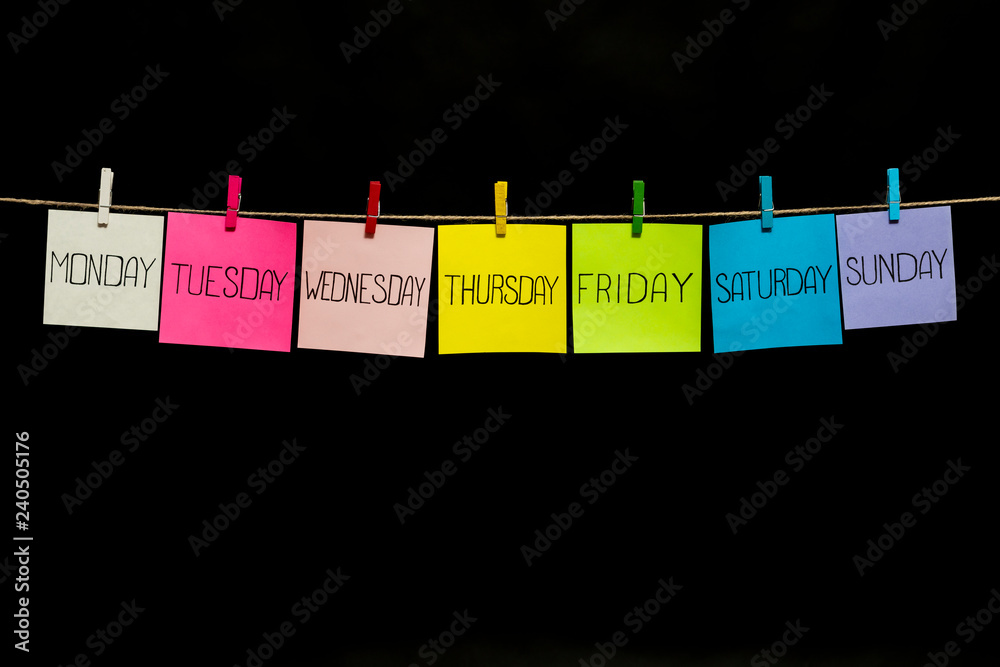 Copy space. Seven multicolored sheets with the names of the days of the ...