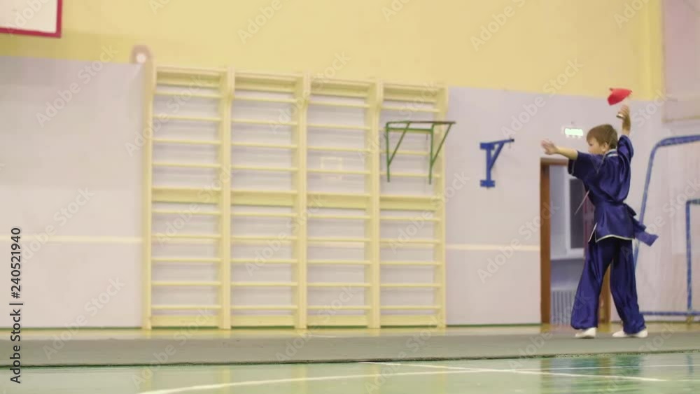 Young boy in traditional yifu chinese clothing training martial arts ...
