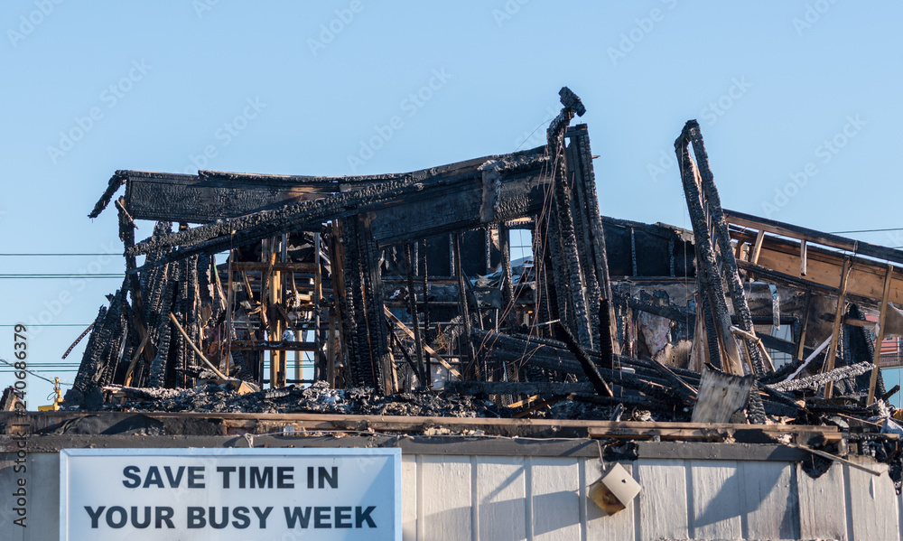 Charred and blackened remains of an office building destroyed by a fire ...