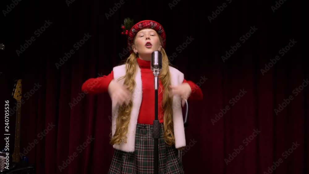 Vidéo Stock Young girl in red Christmas concept singing song front ...