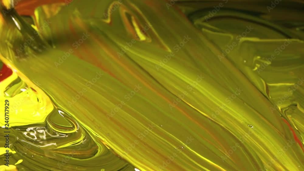 brush smears colored paint. A palette for mixing paints. Artist's tools ...