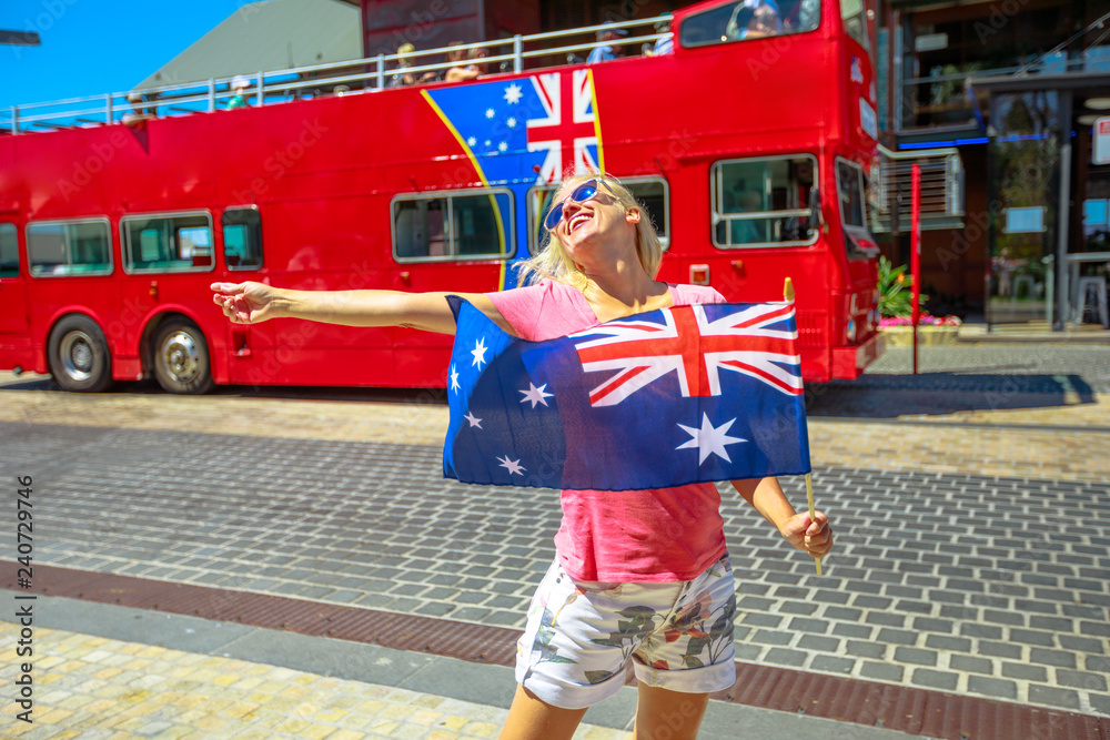 Blonde woman with Australian flag at Barrack Square near Bell Tower and ...
