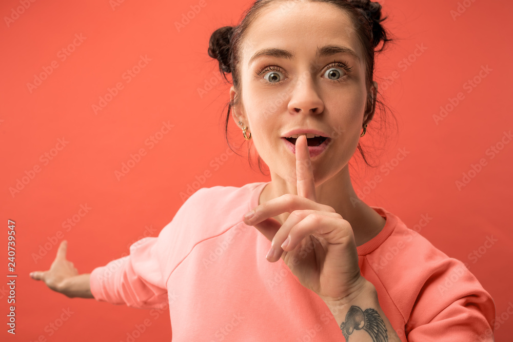 Delight. Beautiful female half-length front portrait isolated on coral ...