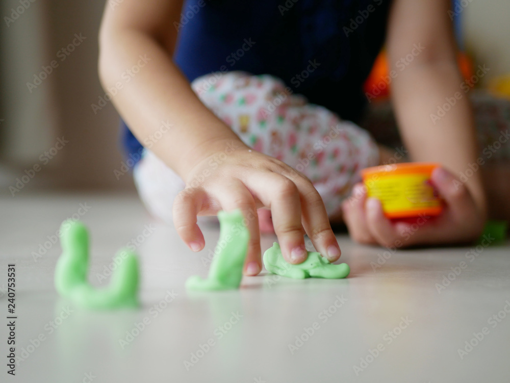Little baby's hand playing playdough on the house floor - playing dough ...