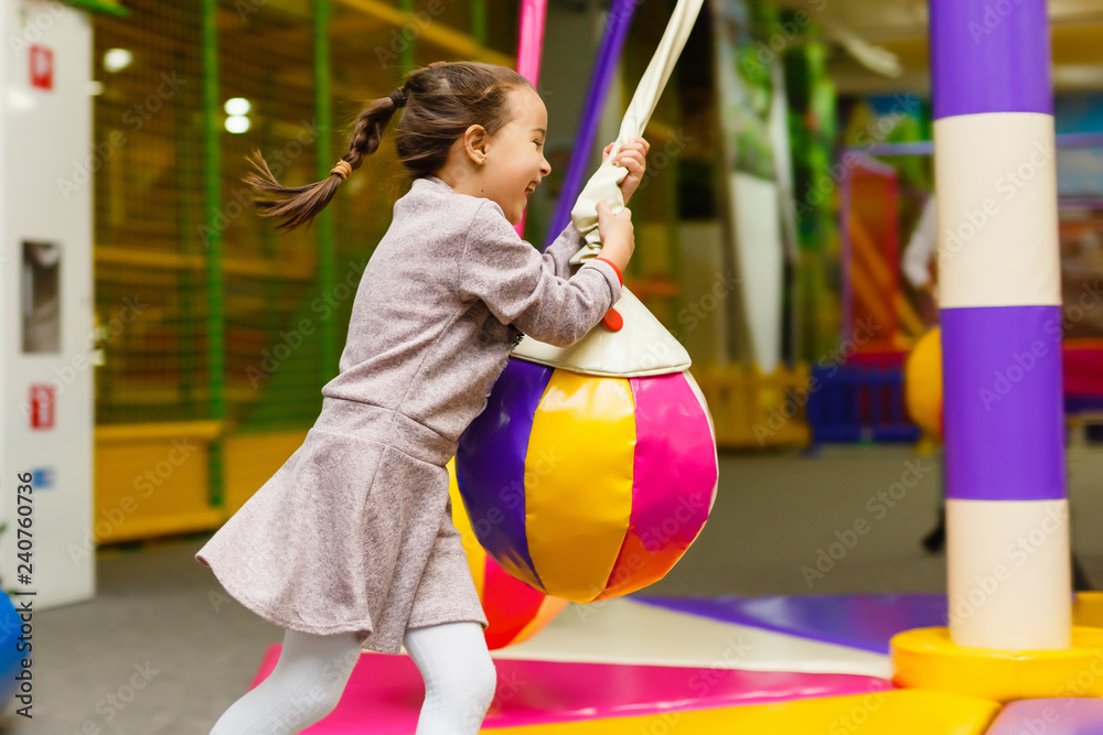 Child jumping on colorful playground trampoline. Kids jump in ...