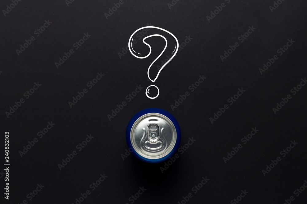 Tin can with a drink on a black background with a question mark ...