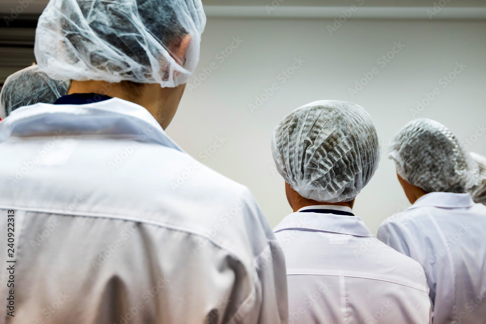 Food factory workers in uniform back view Stock Photo | Adobe Stock