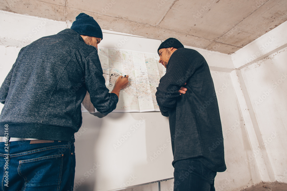 Assaulters making a robbery plan on wall map of the city Stock Photo ...