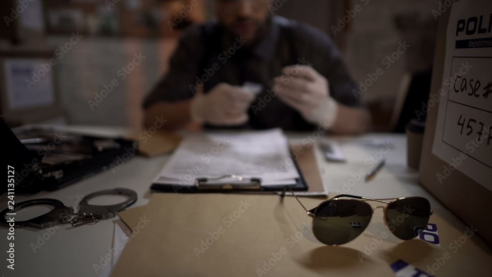 Policeman table, criminalist working, investigating murder, laboratory ...