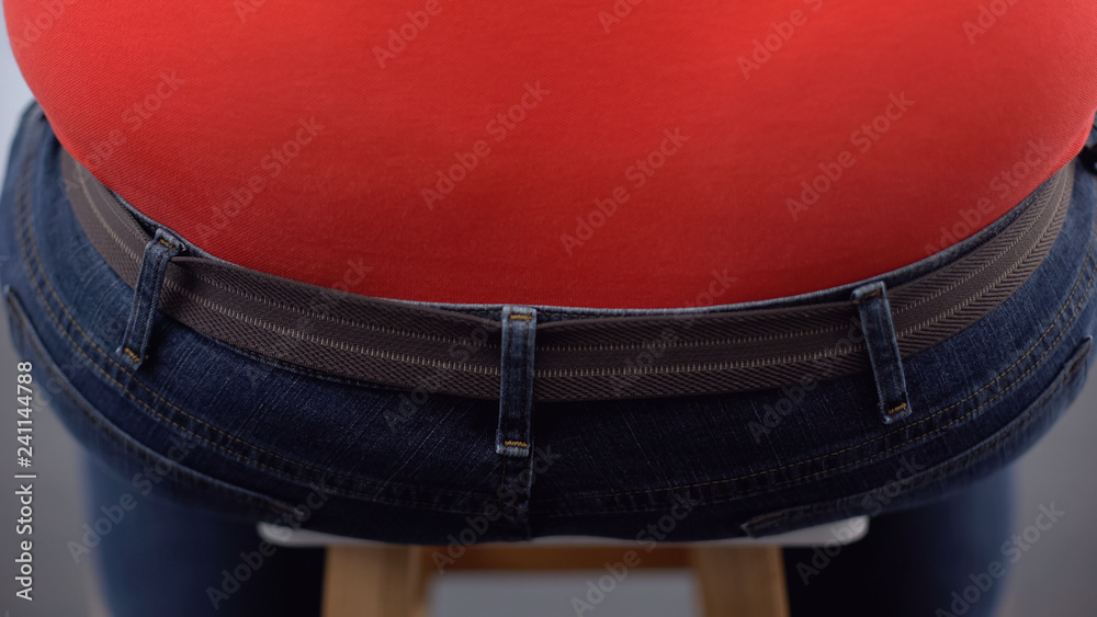Obese man sitting on chair back view, unhealthy nutrition, hormonal ...