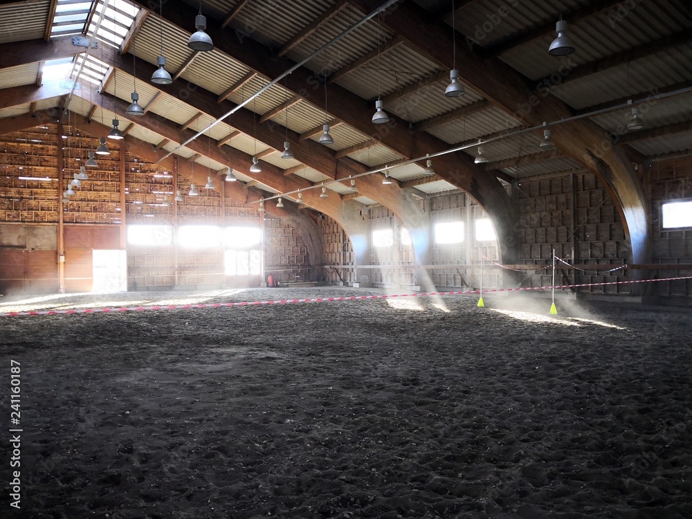 Empty indoor horse riding hall. View in an indoor riding arena. The ...