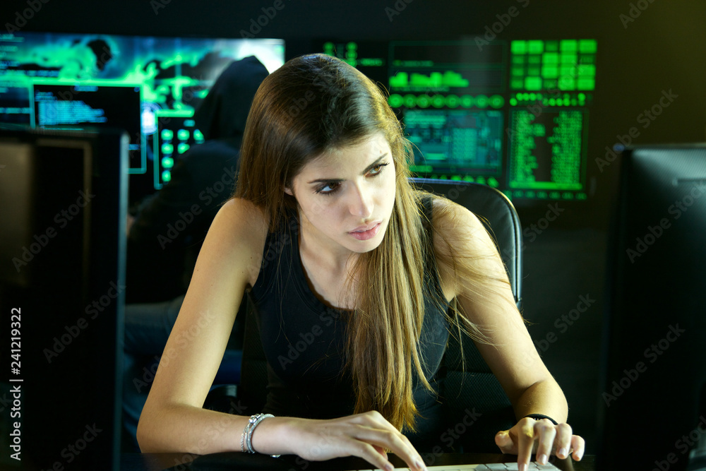 Young female hacker studying code with partner in crime Stock Photo ...