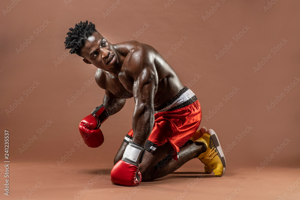 Muscular African American Black male sweaty boxer on knees, knocked ...