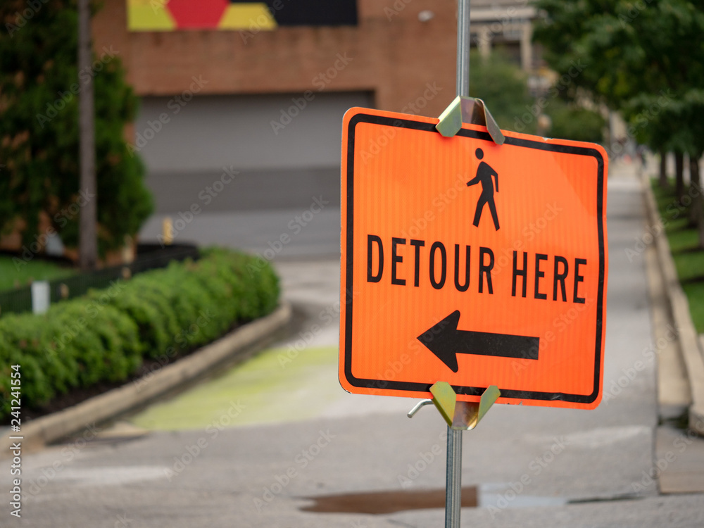 Detour here sign with person walking symbol and arrow pointing left ...