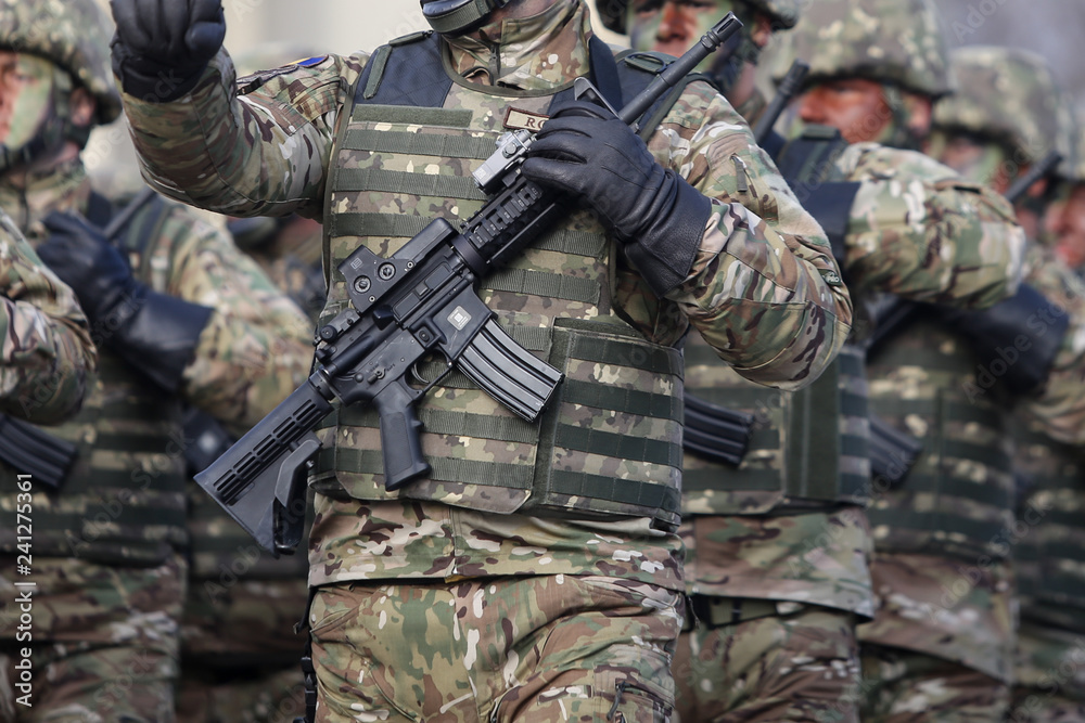 Romanian special forces soldiers, armed with M4A1 5.56×45mm NATO ...