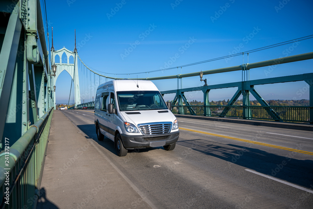 Compact cargo mini van running on St Johns Bridge in Portland ...